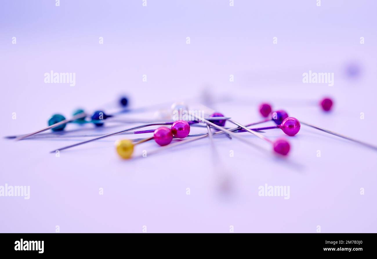 Closeup, sewing pin and design in studio by purple background for ...
