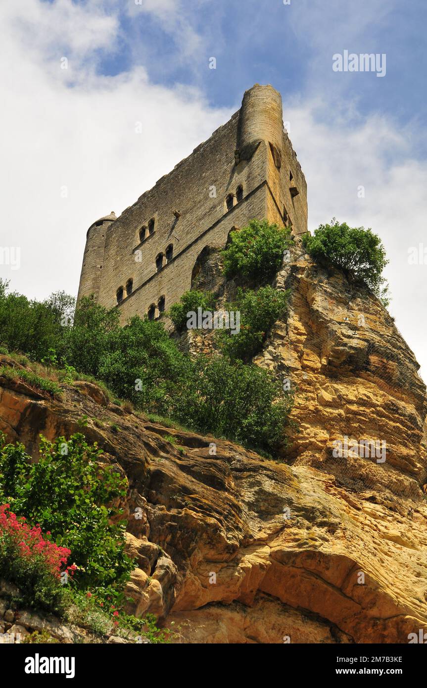 A vertical shot of the famous Beynac Castle on top of a cliff in France ...