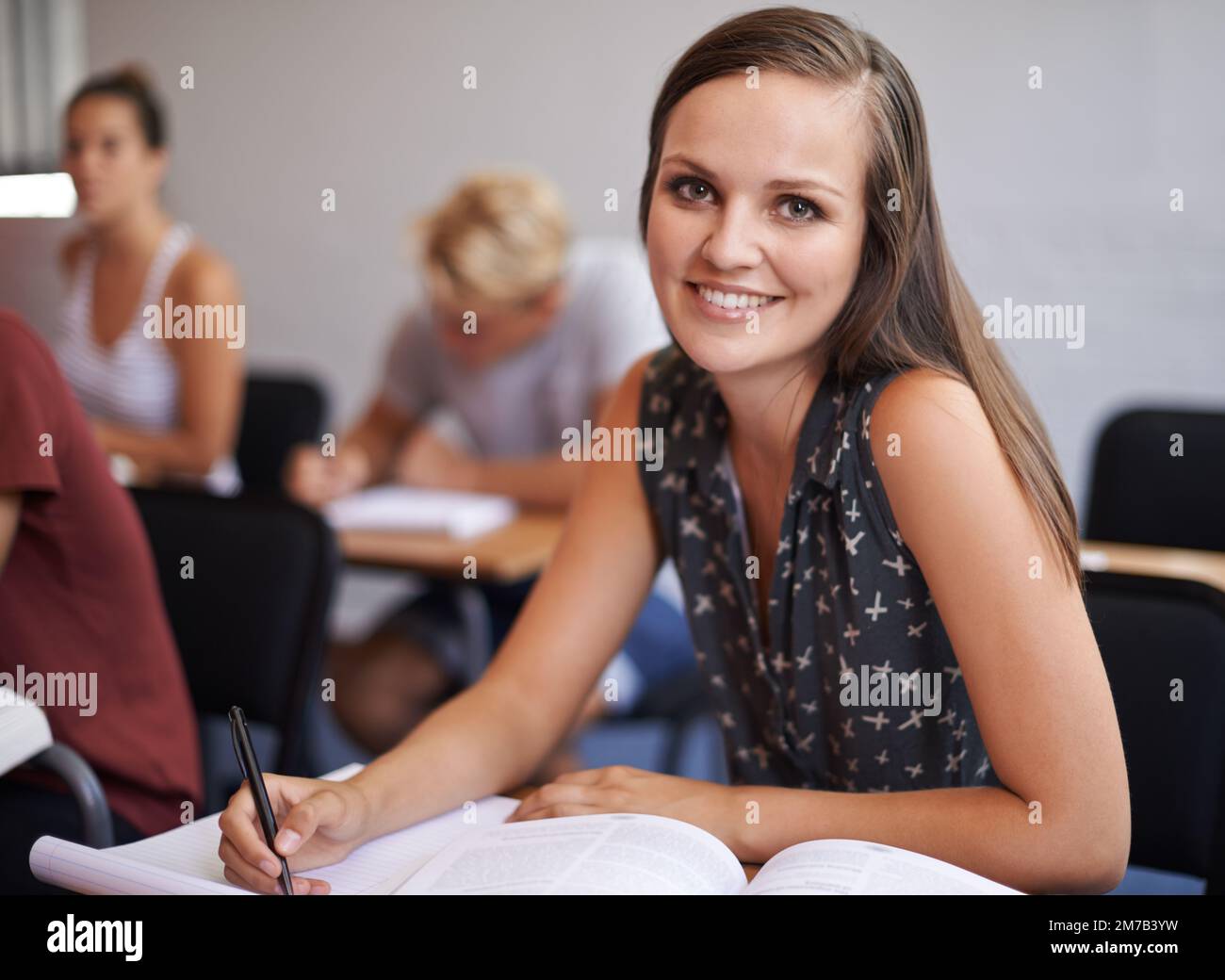 Working toward an A. An attractive young varsity student sitting in a ...