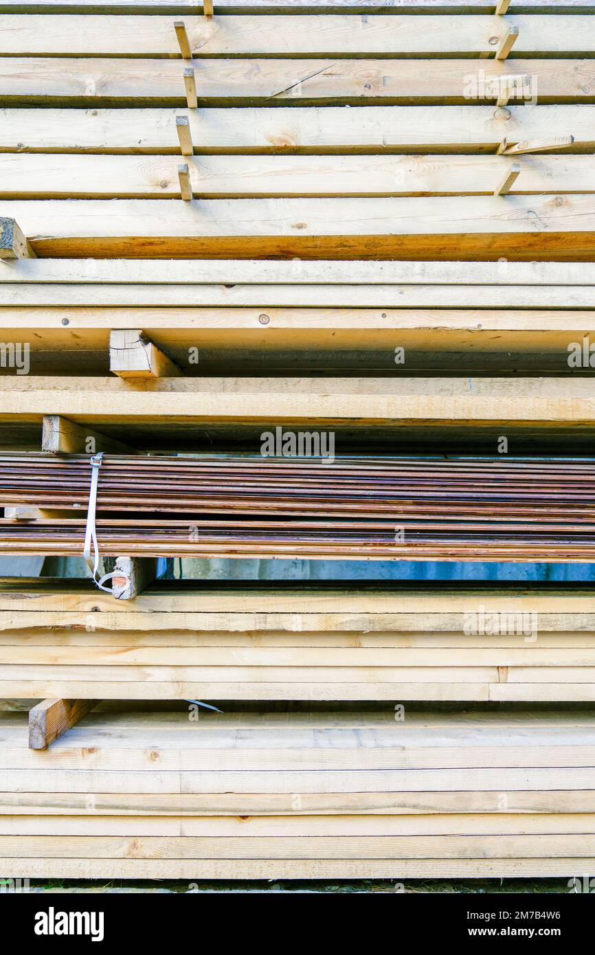 Stacked timber. Timbers ready for sale on the timber site. Withstanding ...