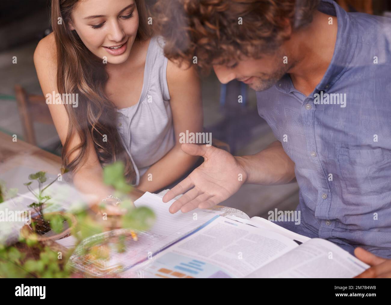 Lets go over it one more time. two young students studying in a coffee ...