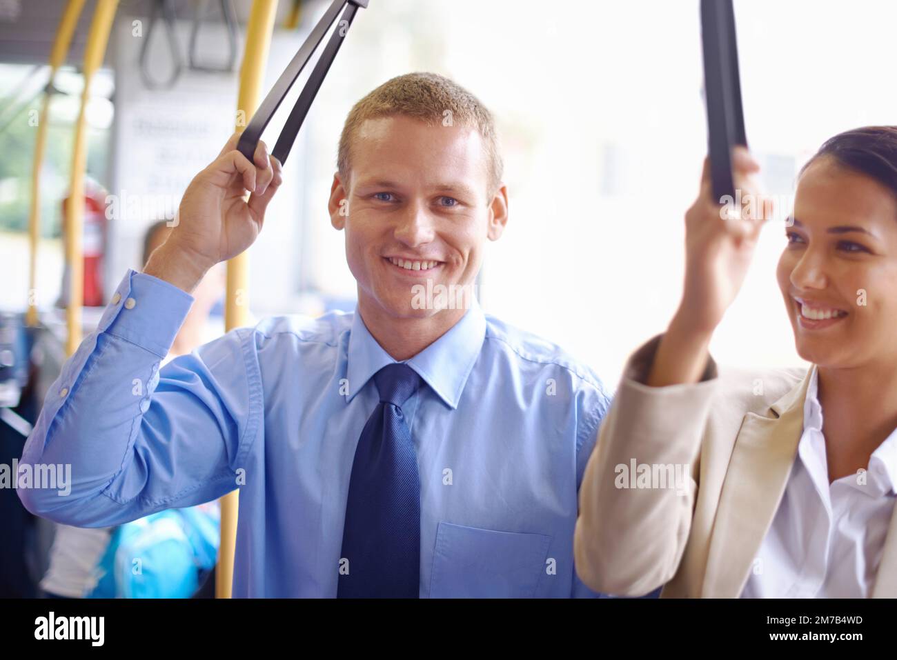 The bus is best for us. Two young colleagues traveling on the bus and ...