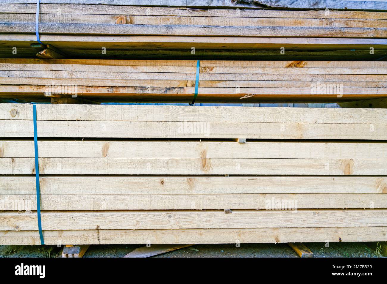 Stacked timber. Timbers ready for sale on the timber site. Withstanding ...