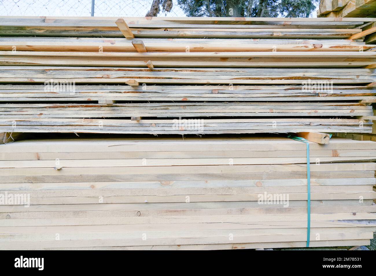 Stacked timber. Timbers ready for sale on the timber site. Withstanding ...