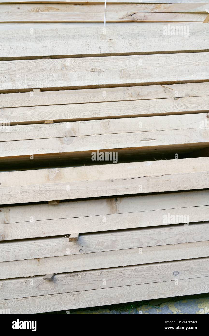 Stacked timber. Timbers ready for sale on the timber site. Withstanding ...