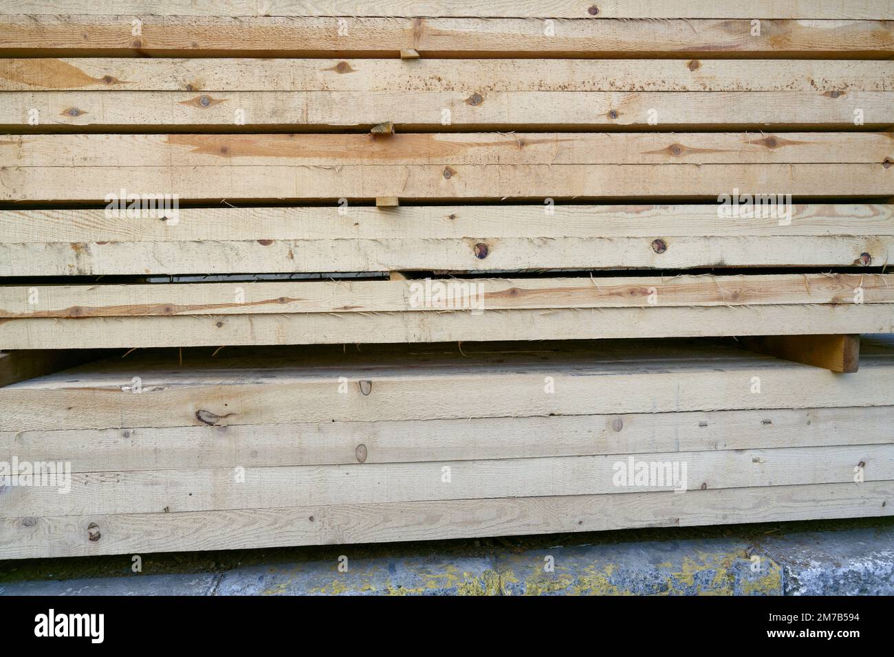 Stacked timber. Timbers ready for sale on the timber site. Withstanding ...
