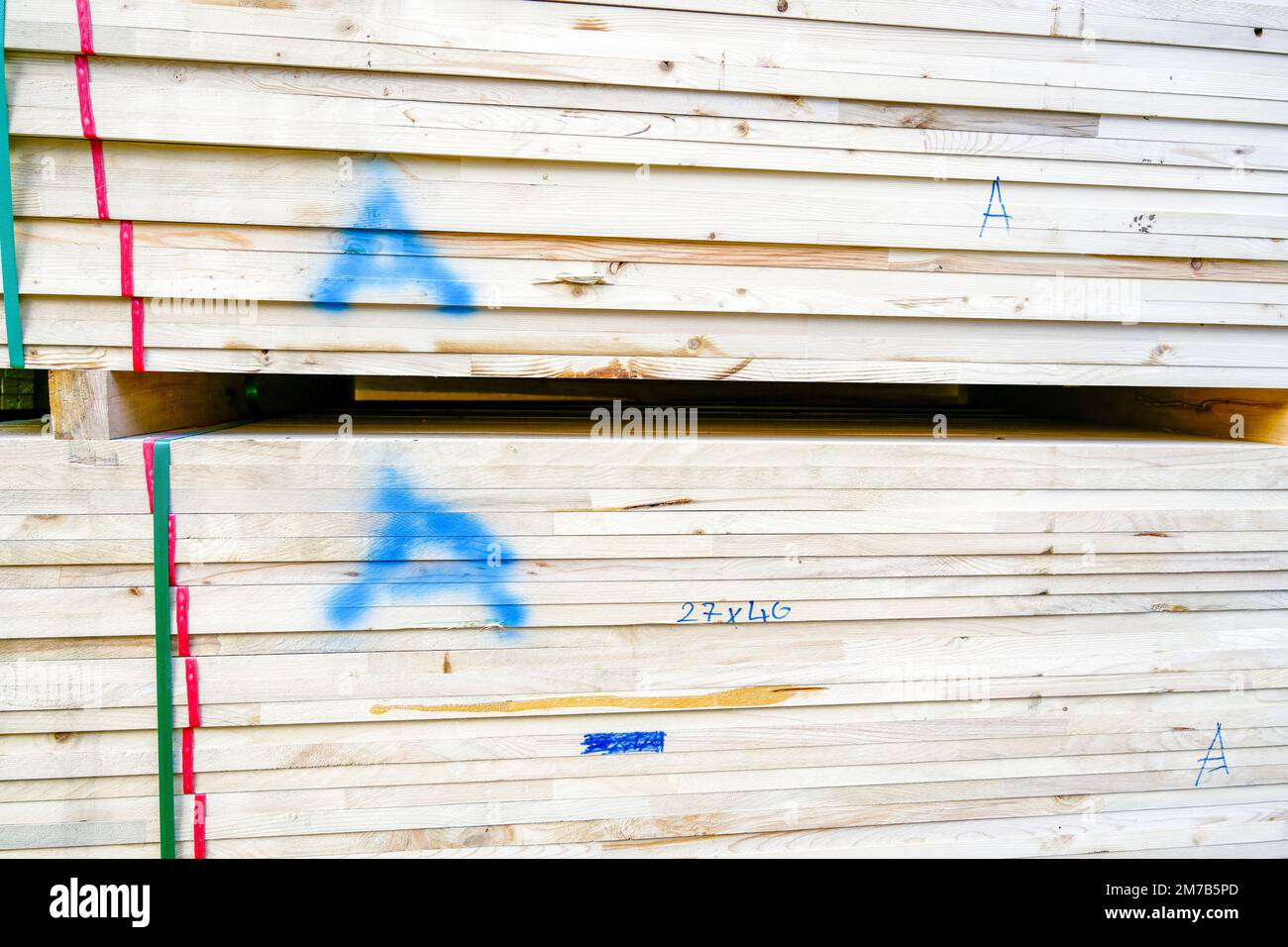 Stacked timber. Timbers ready for sale on the timber site. Withstanding ...