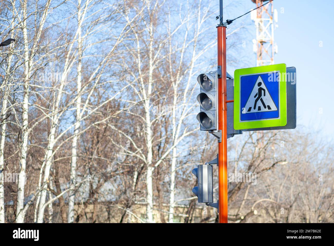 A pedestrian crossing sign with a reflective coating and a traffic ...