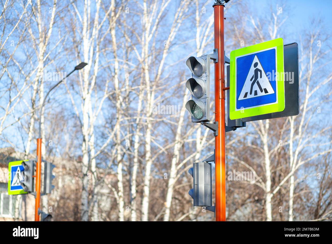 A pedestrian crossing sign with a reflective coating and a traffic ...