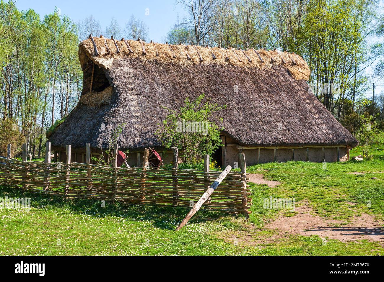 Longhouse and a wood fence Stock Photo - Alamy