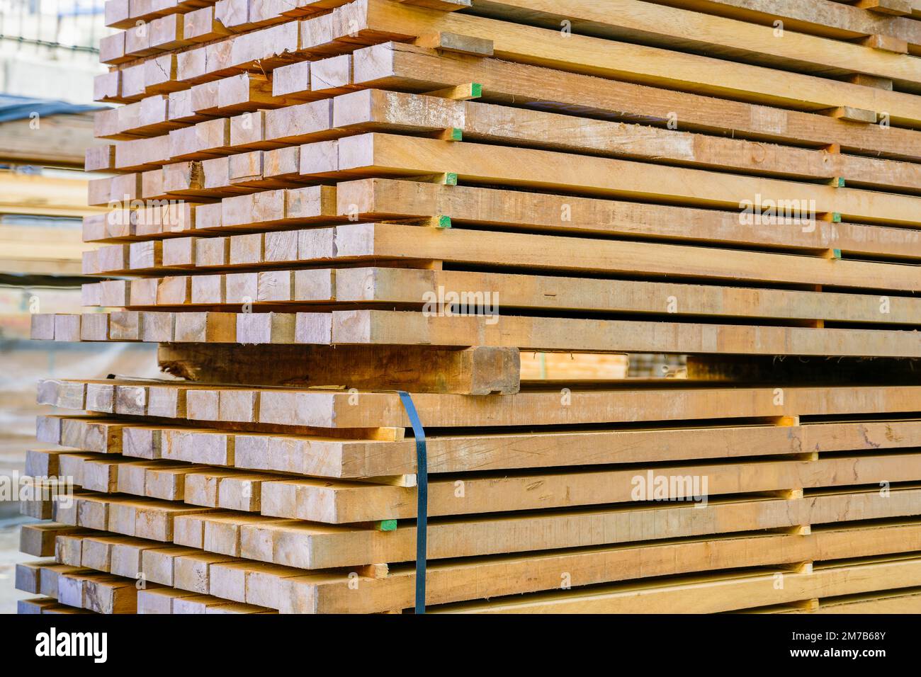 Stacked timber. Timbers ready for sale on the timber site. Withstanding ...