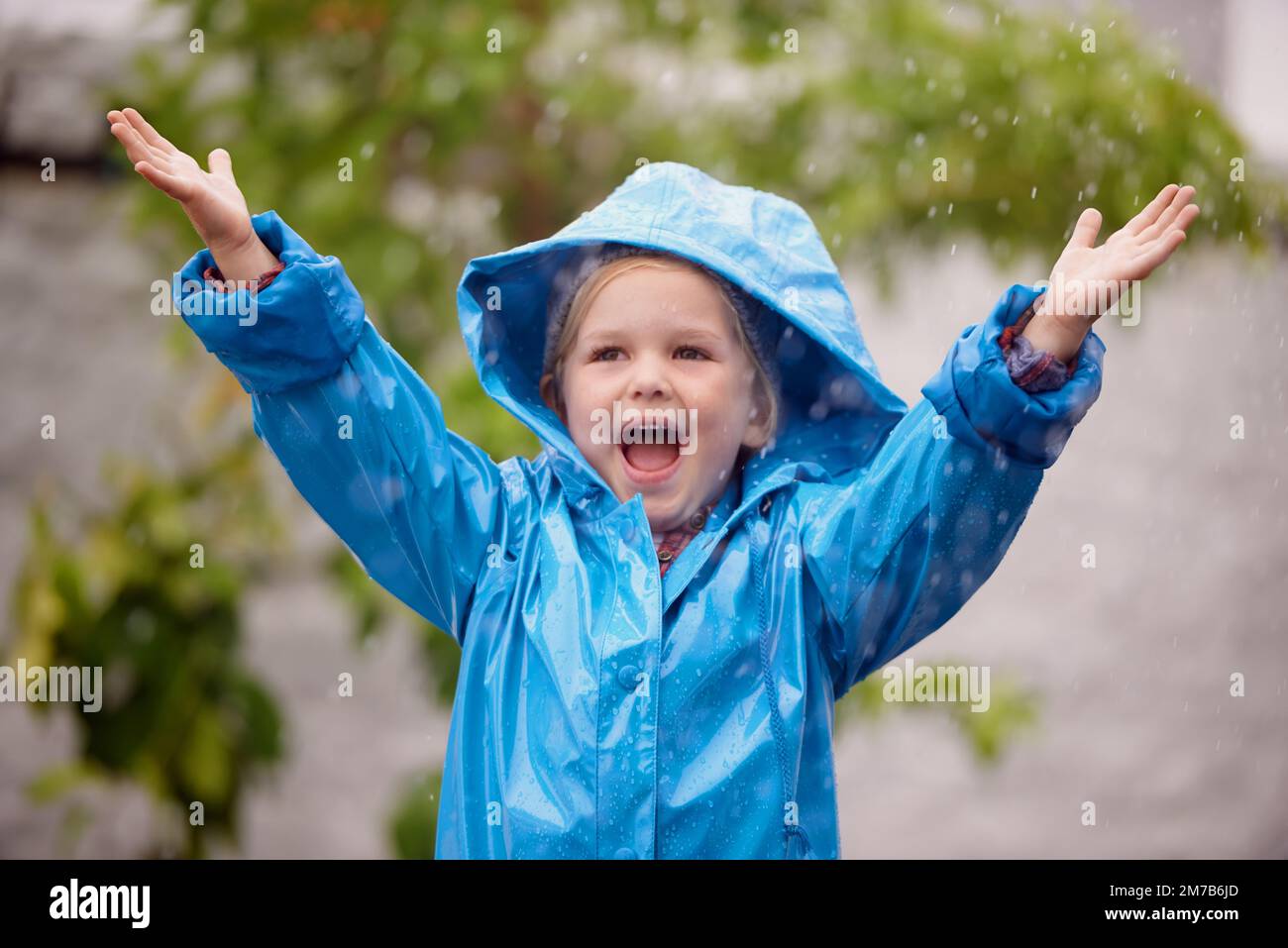 Happiness is dancing in the rain. an adorable little girl playing ...
