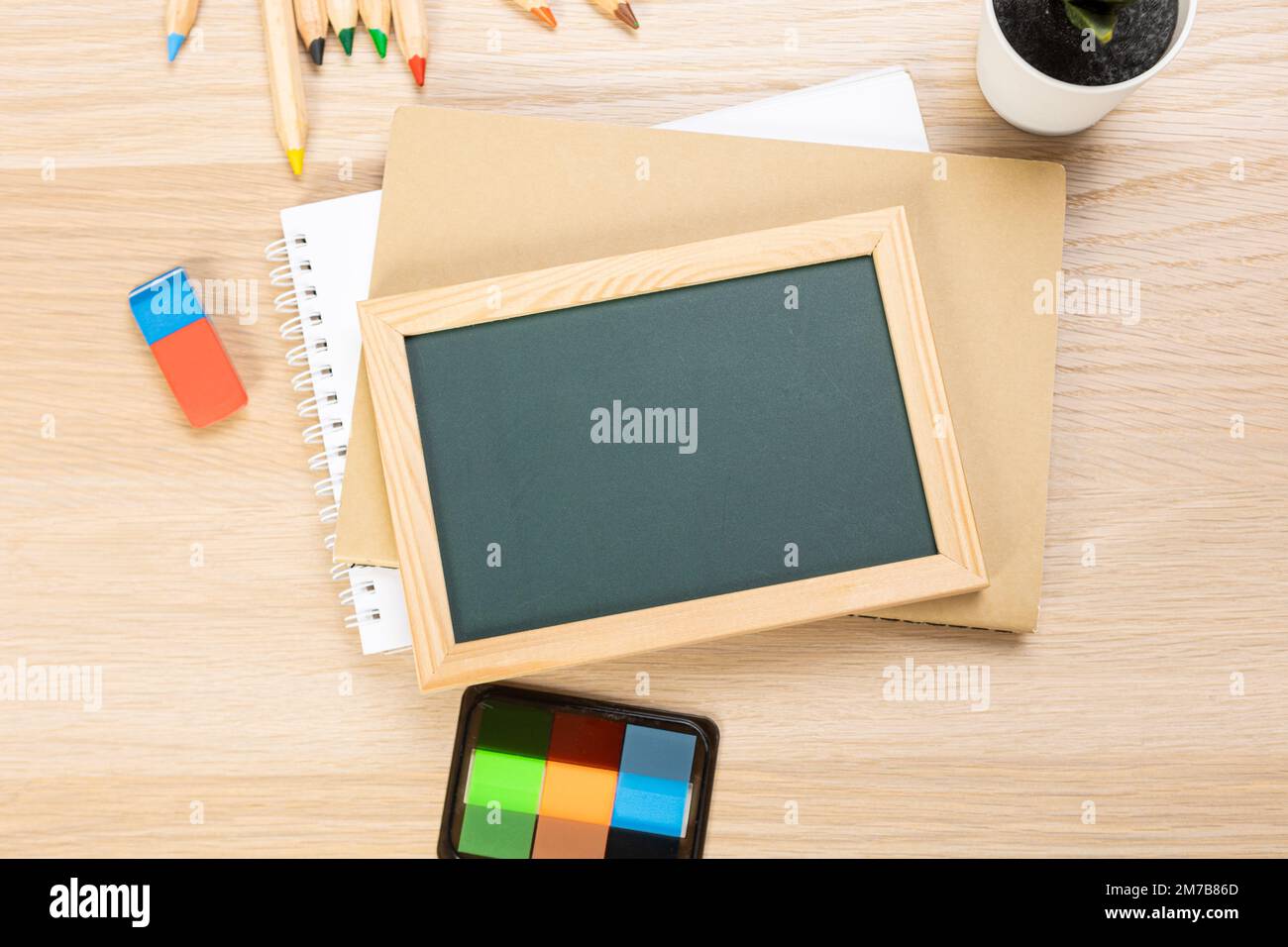 School chalkboard mockup on work desk. Composition of a student's desk ...