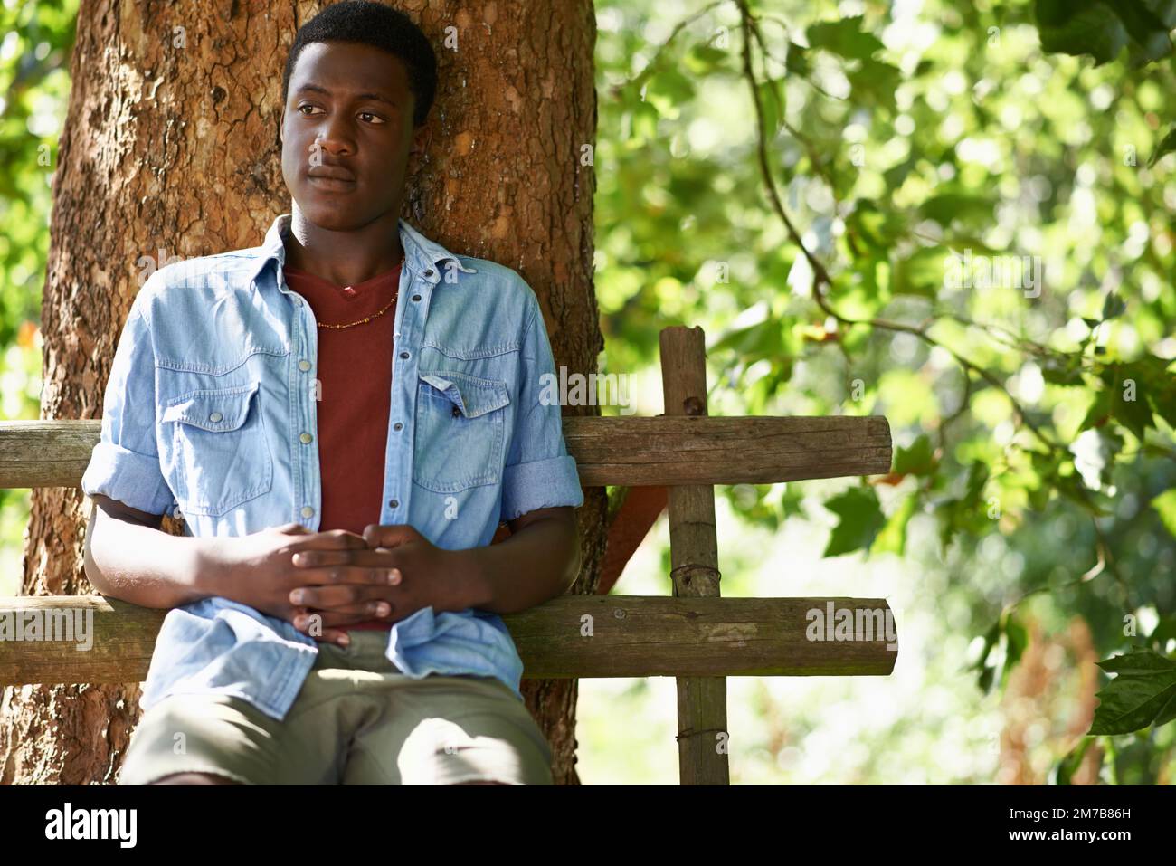 Spending some quality time outdoors with myself. a teenage boy relaxing ...