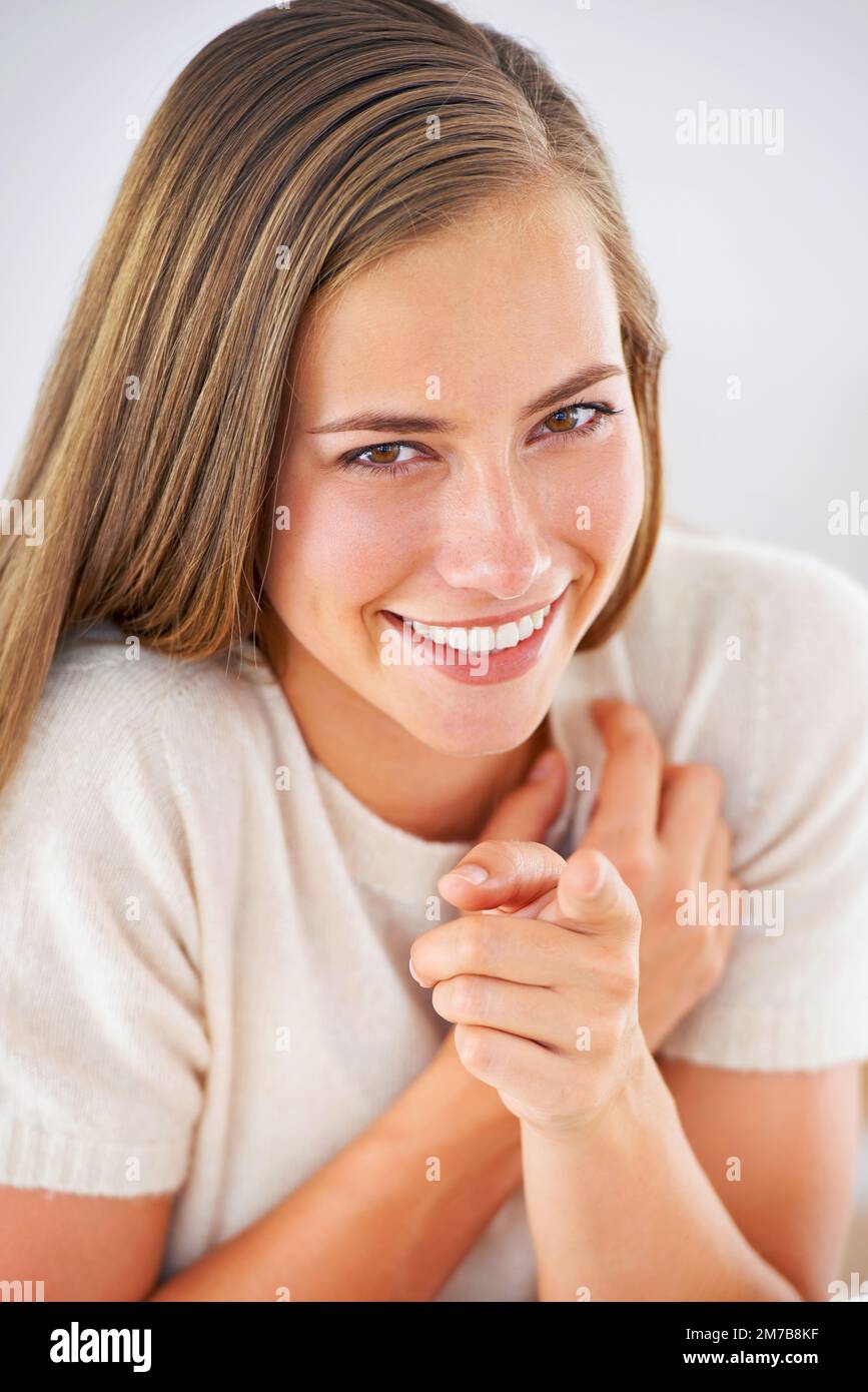 You know what you did...Portrait of an attractive young woman pointing ...