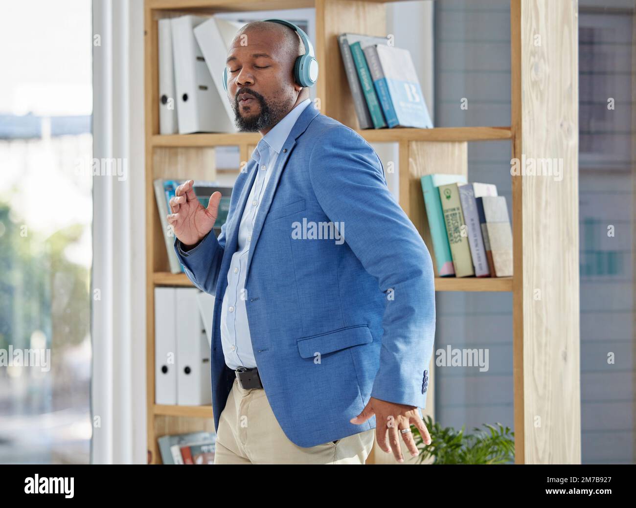 Music, dance and headphones with a business black man manager dancing ...