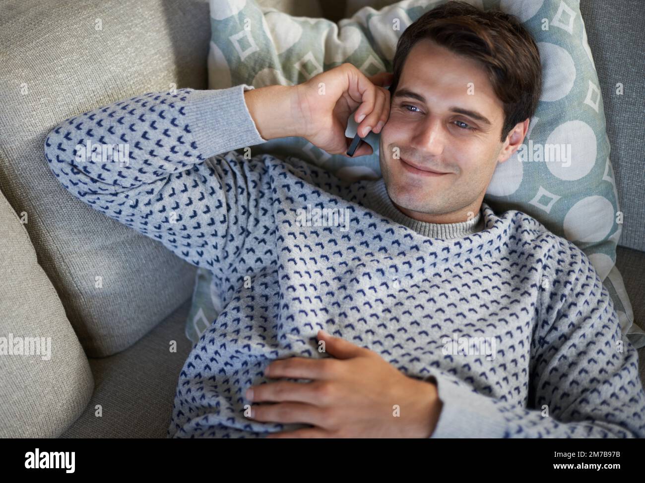 Picturing her smile on the other side of the line. a young man on his ...