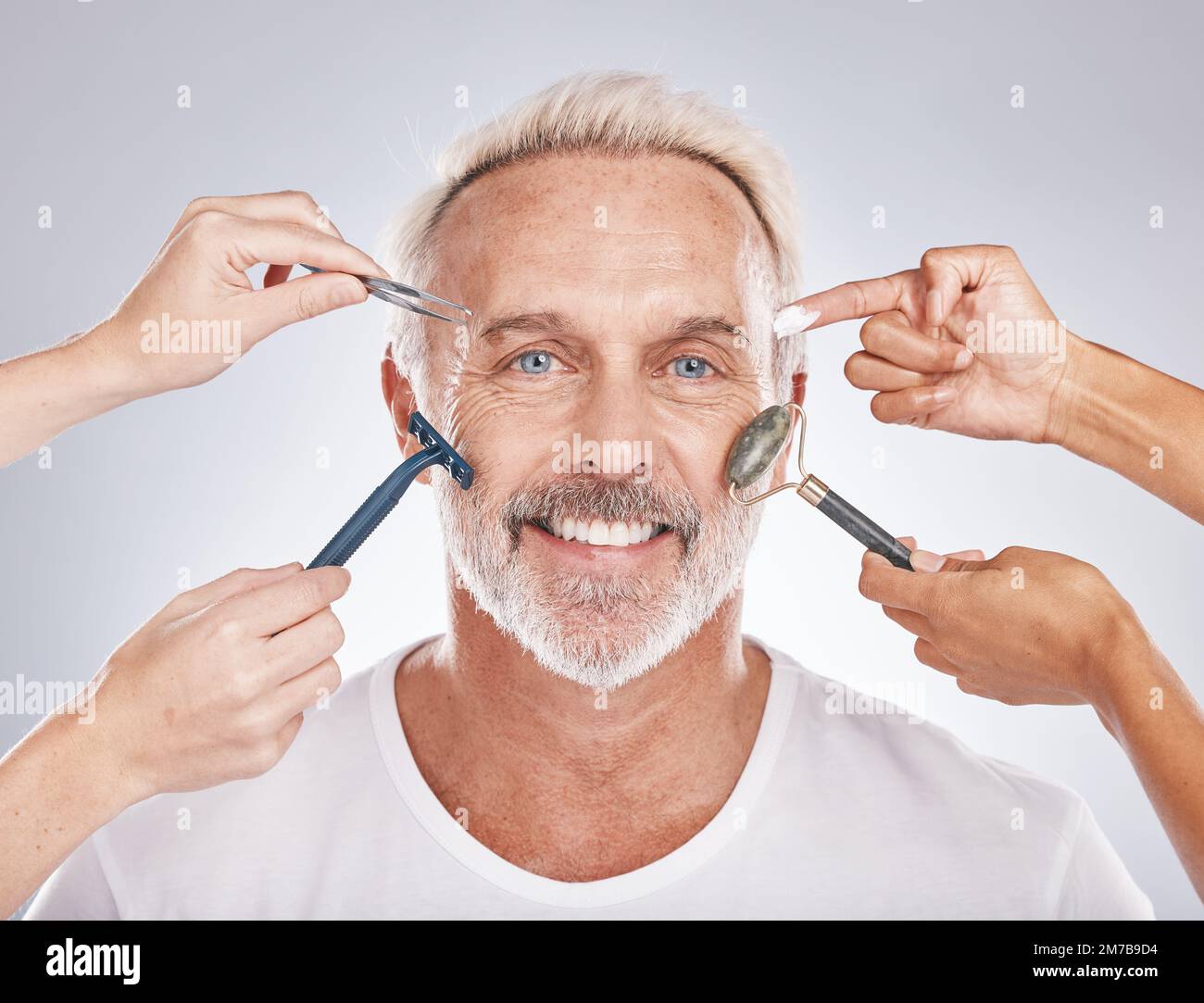Senior man, skincare and studio portrait with shaving, self care and jade roller guasha by gray ...