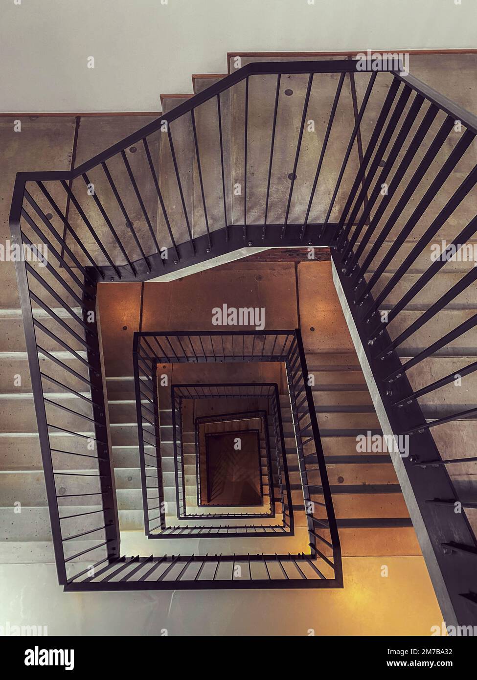 A top view of concrete staircase and black steel railing in a ...