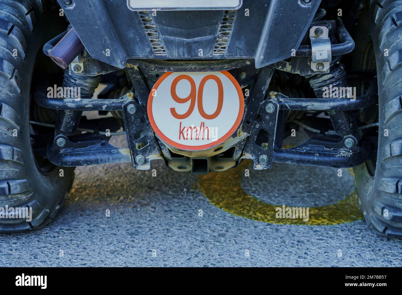 A Red "90km h" sign attached to a blacquad bike Stock Photo - Alamy
