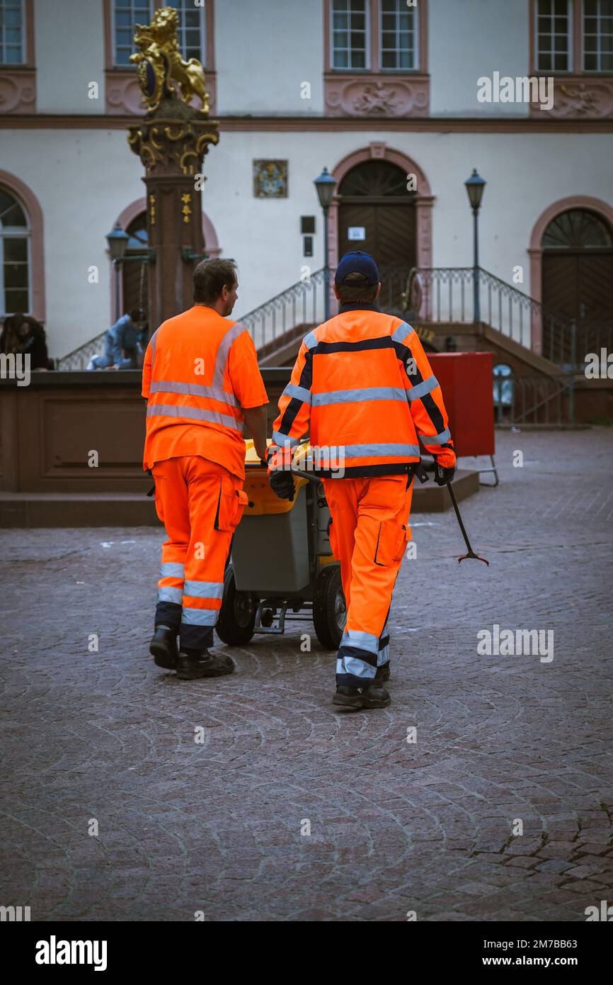 A back view of two garbage men at work talking to each other Stock ...