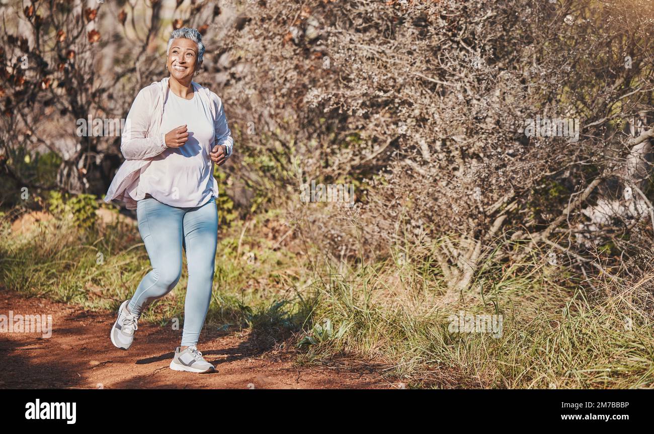 Fitness, happy and senior woman running in nature for cardio, morning ...