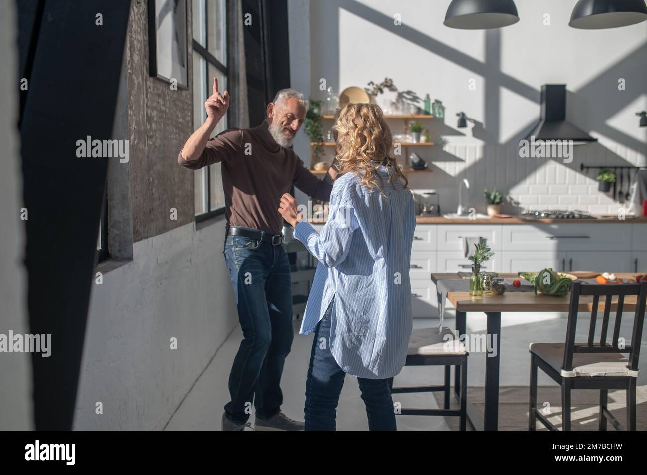 A mature couple dancing in the kitchen Stock Photo - Alamy