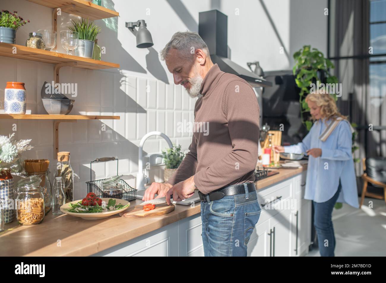 Mature couple cooking breakfast together Stock Photo - Alamy