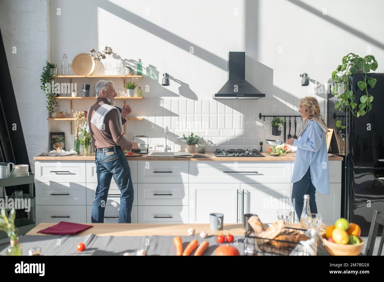 Mature couple cooking breakfast together Stock Photo - Alamy