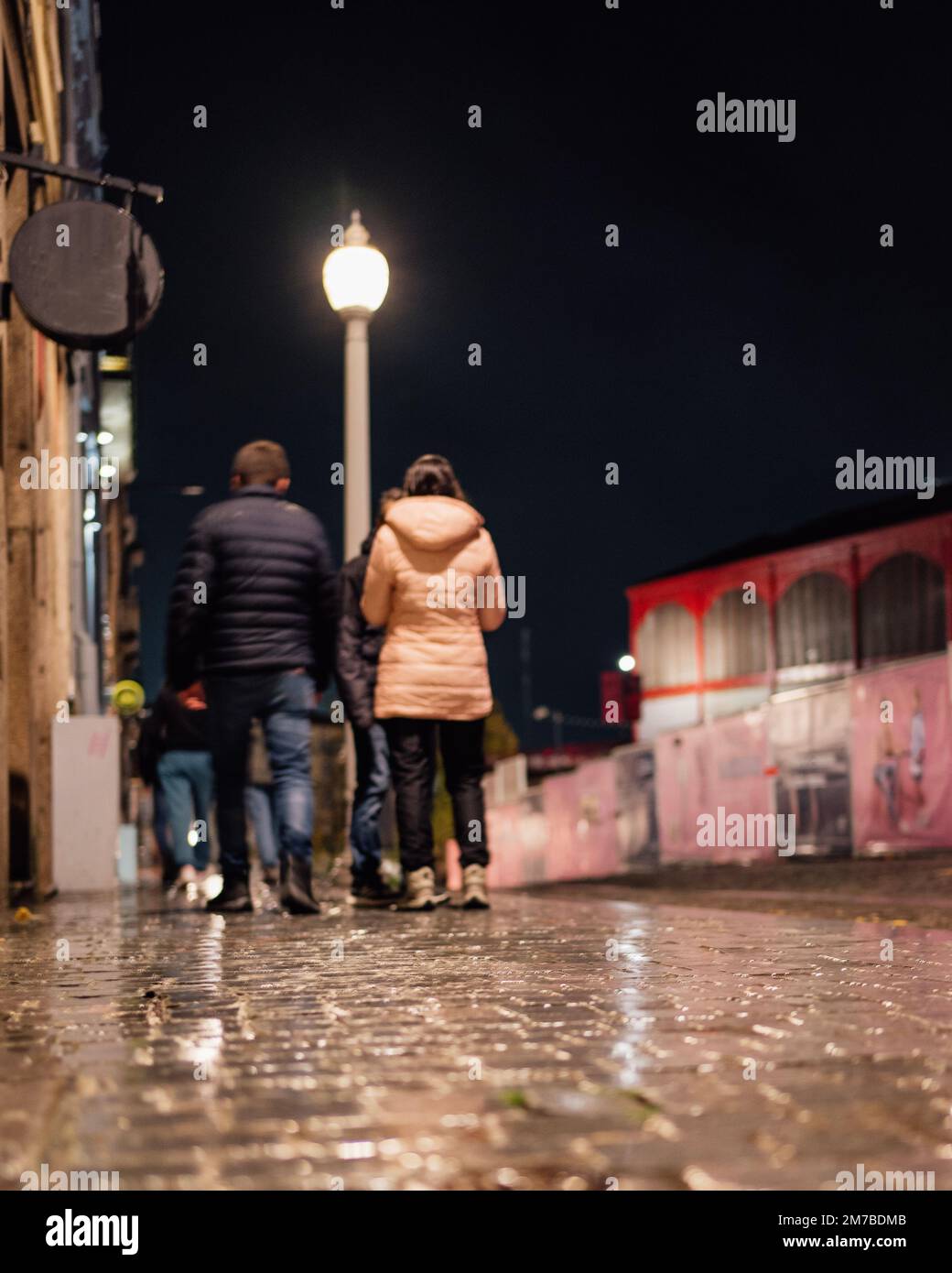 People Walking On Street At Night