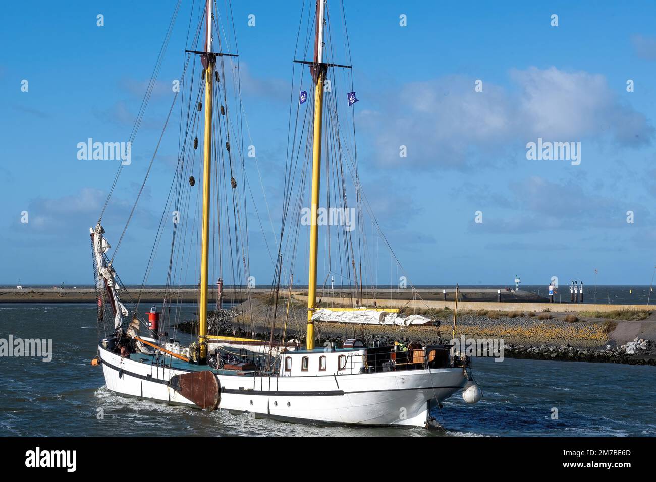 A large pirate-style ship sailing on blue water near a dock Stock Photo ...
