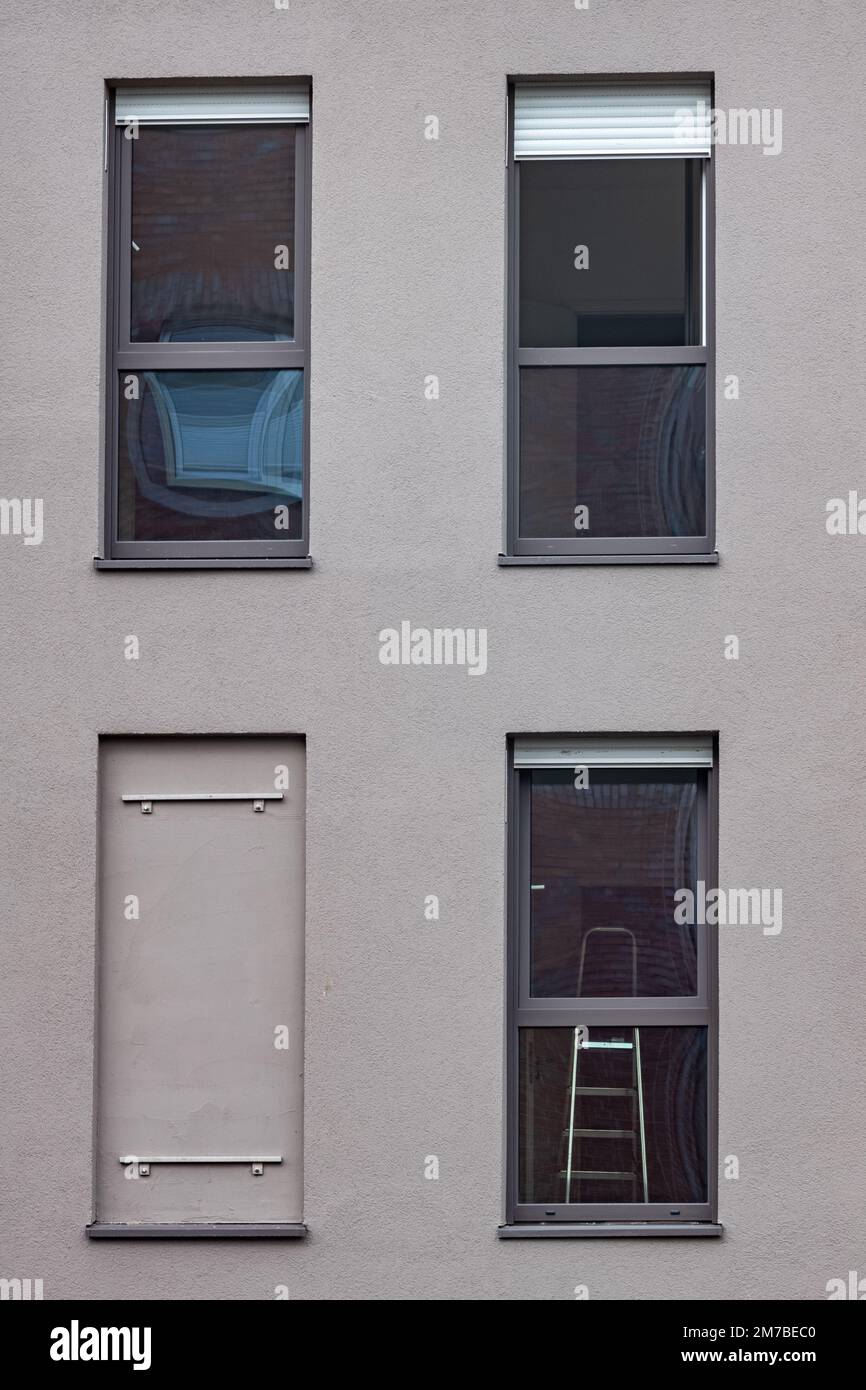 A vertical shot of uniform rectangular windows of a building Stock ...