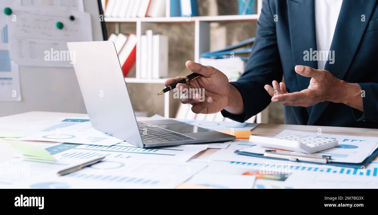 Close up a man working about financial with calculator at his office to ...