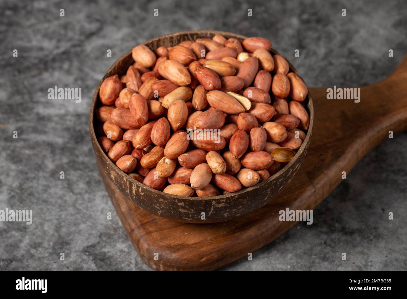 Peanuts on dark background. Peanuts in a coconut bowl. Studio shoot ...