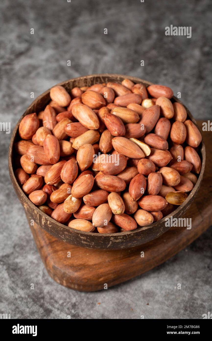 Peanuts on dark background. Peanuts in a coconut bowl. Studio shoot ...