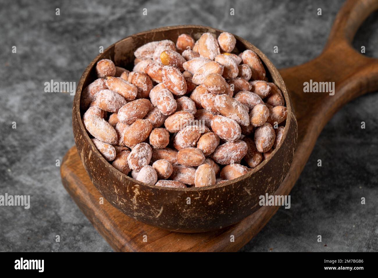 Salted peanuts on dark background. Peanuts in a coconut bowl. Studio ...