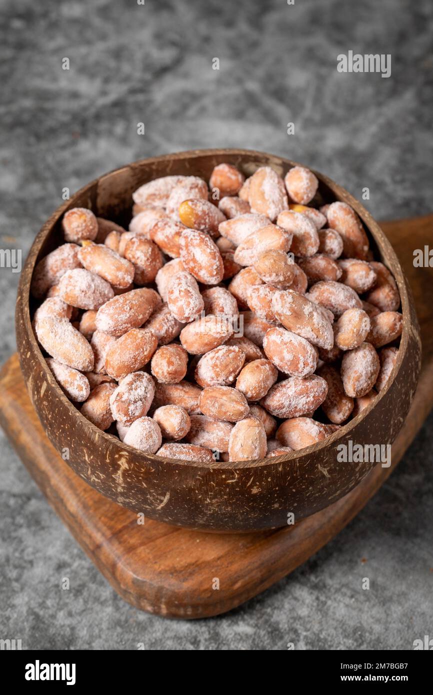 Salted peanuts on dark background. Peanuts in a coconut bowl. Studio ...