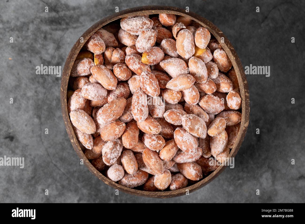 Salted peanuts on dark background. Peanuts in a coconut bowl. Studio ...