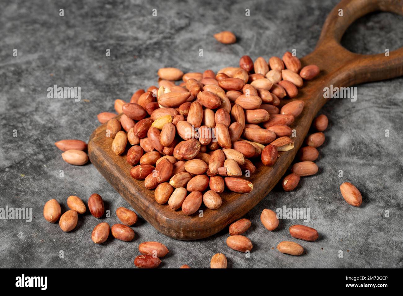 Peanuts on dark background. Peanuts on wood serving board. Studio shoot ...