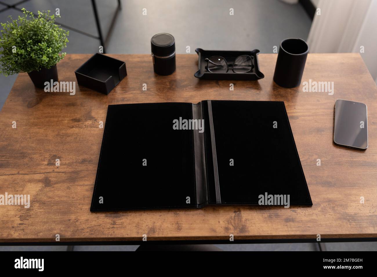 workplace in the office with a leather folder for papers on the table ...