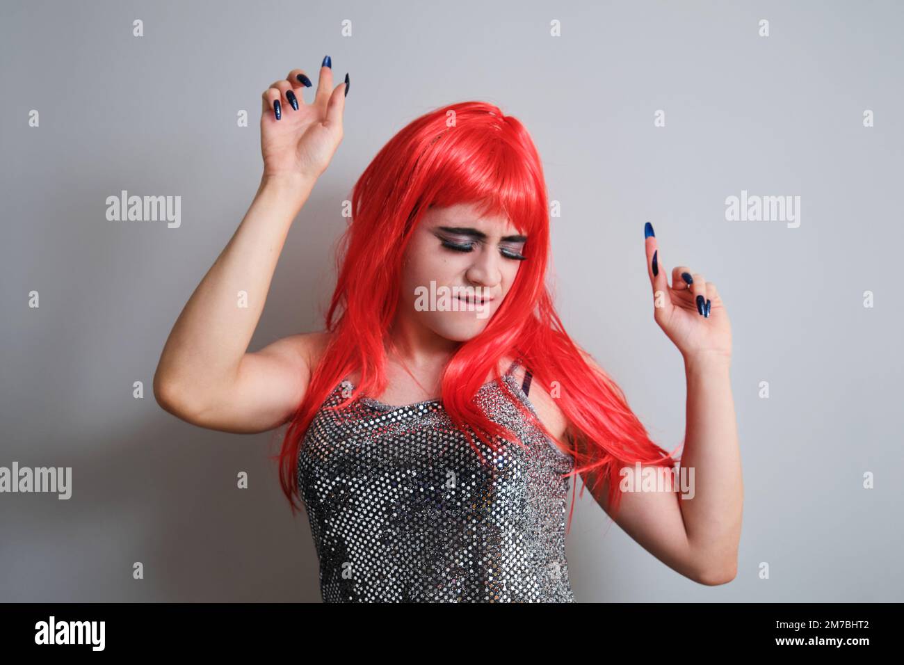 Portrait of drag queen wearing a red wig and dancing Stock Photo - Alamy