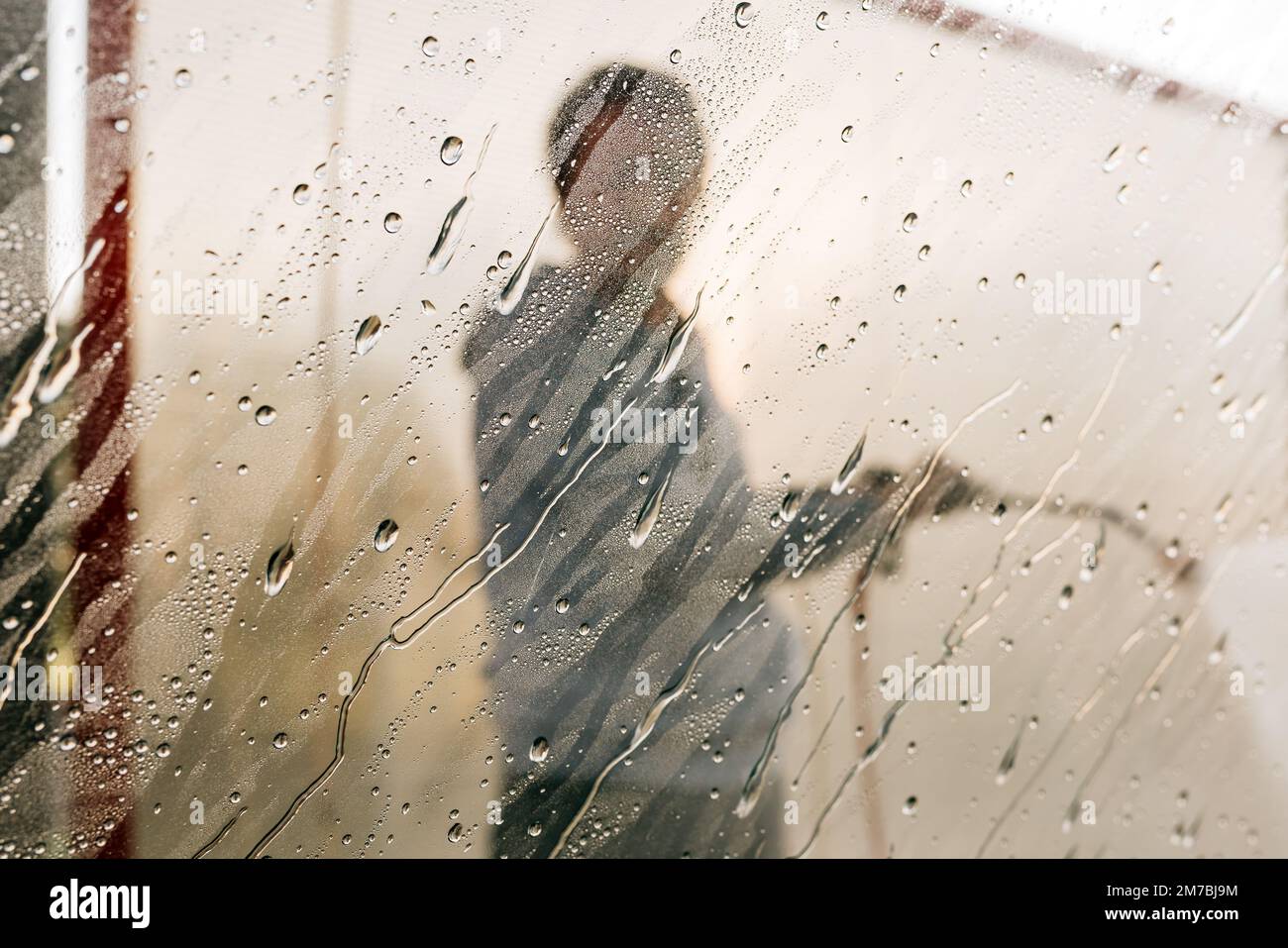 Man washing car with water gun in carwash self-service. Soap sud, wax ...