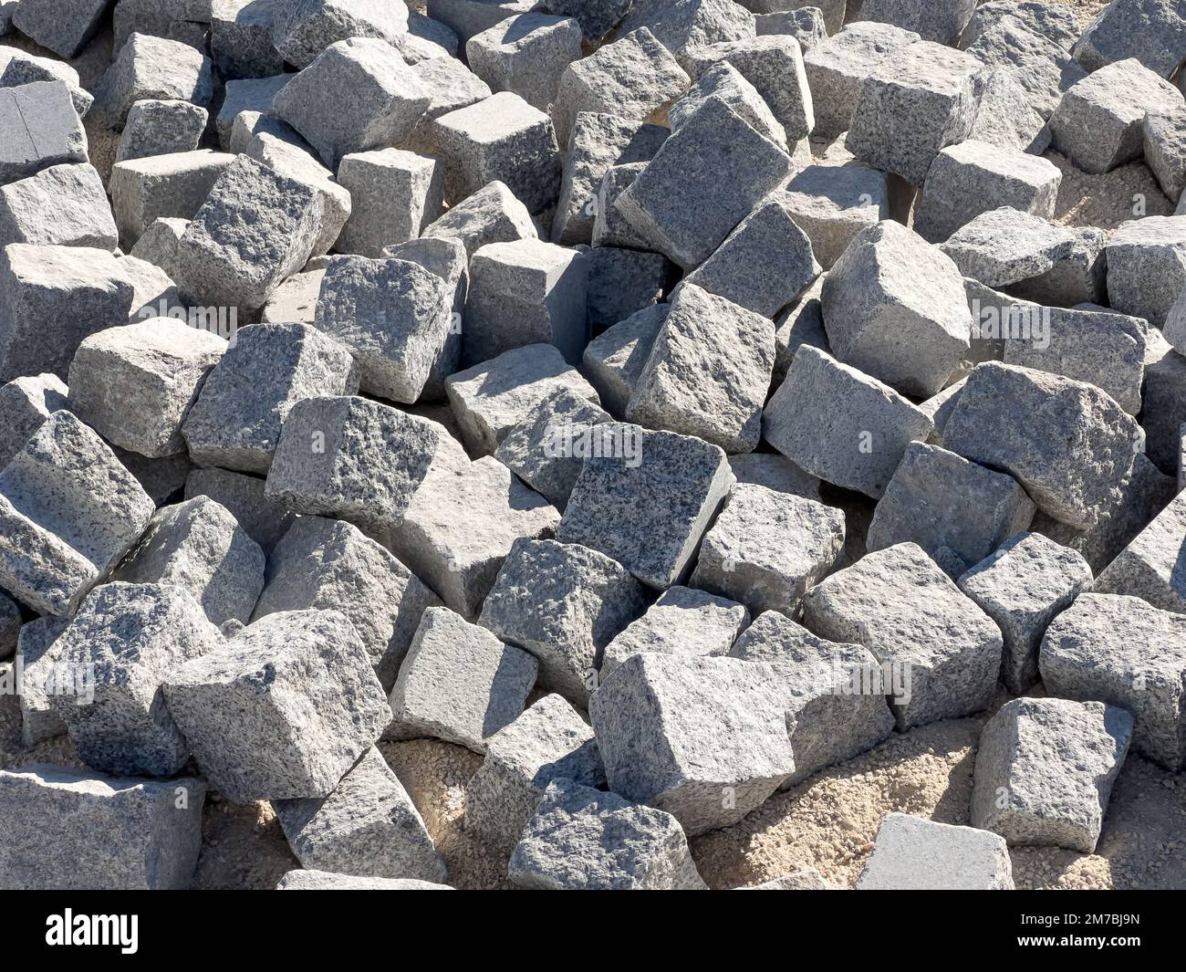 heap of cobblestones background, paving stone building material at ...