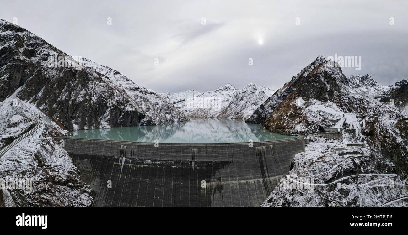 Amazing drone footage over an alpine lake, hydro dam and vast Alpine ...