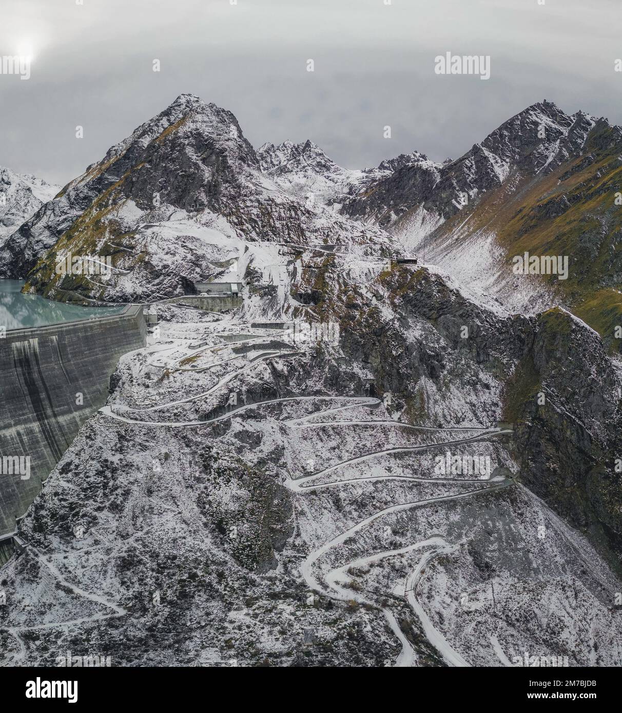 Amazing drone footage over an alpine lake, hydro dam and vast Alpine ...