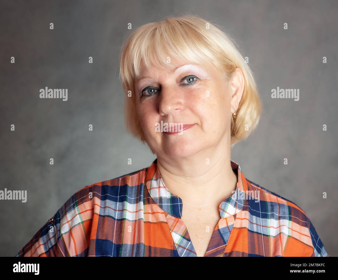 Middle aged woman portrait on dark background. Color toned image Stock ...