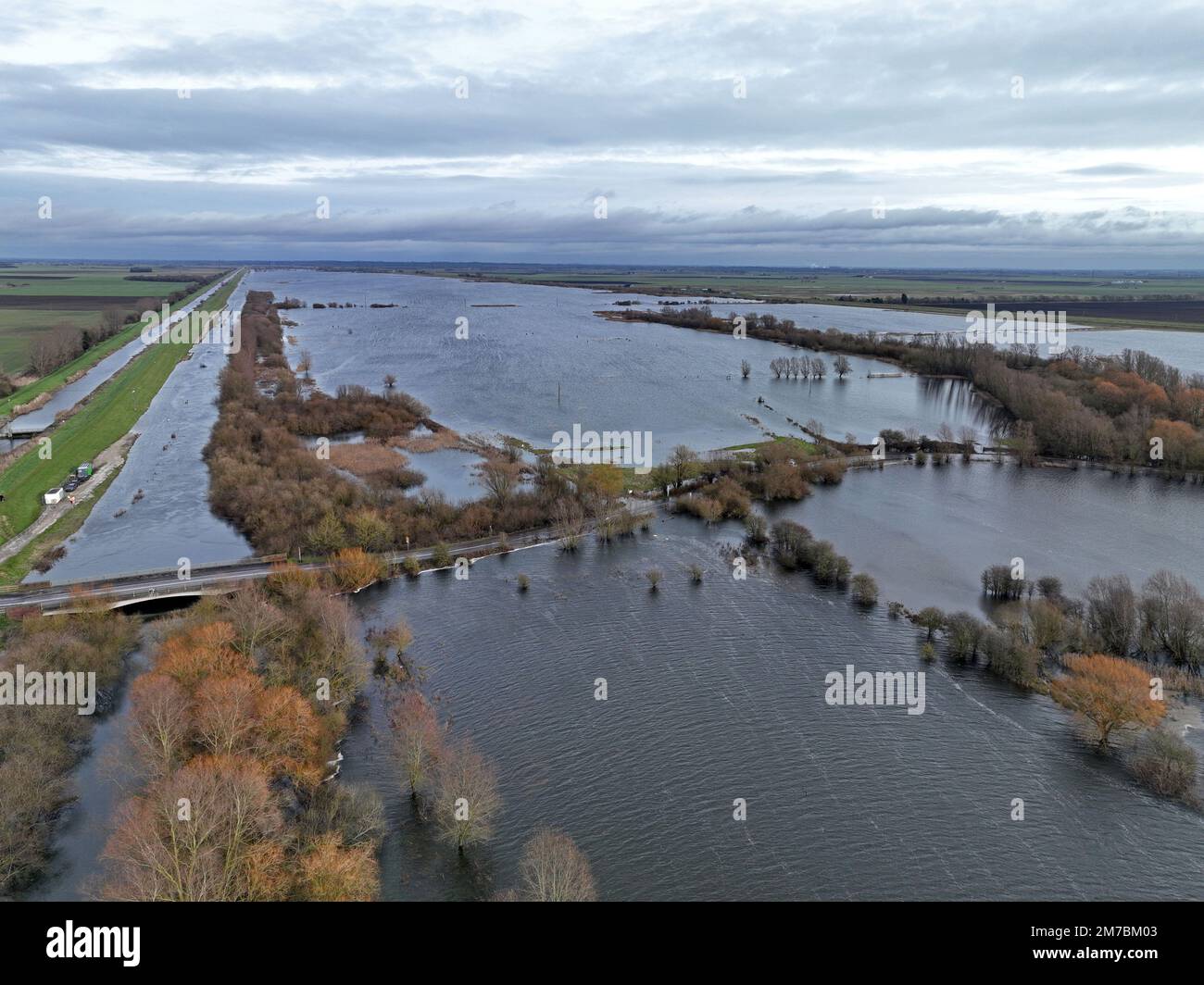 The Welney wash fills with floodwater and the road is becoming flooded ...