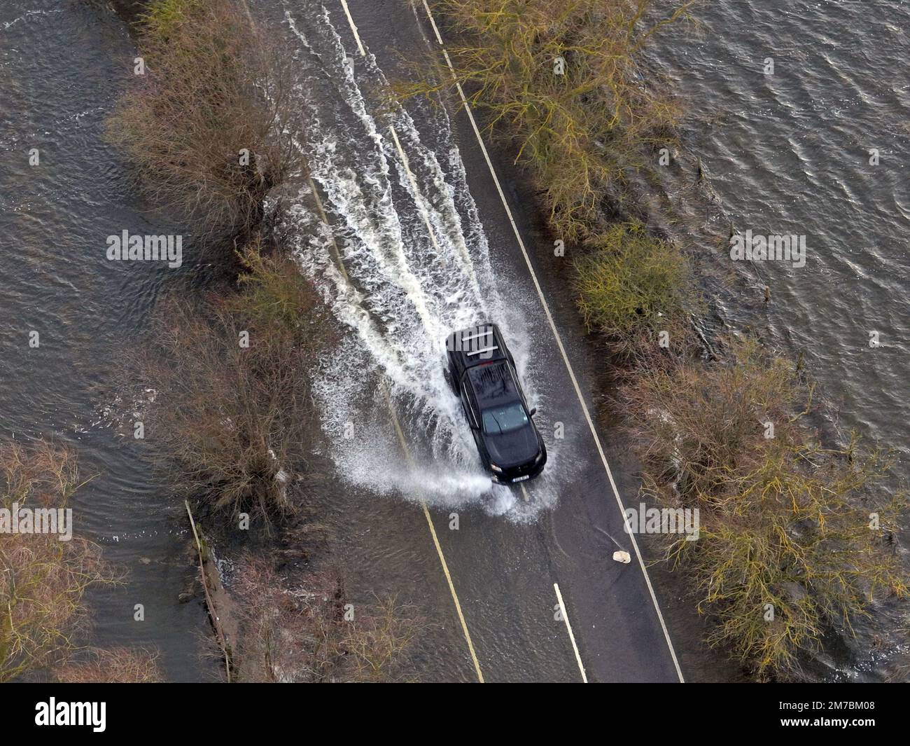 A vehicle travels along the road as the Welney wash fills with ...