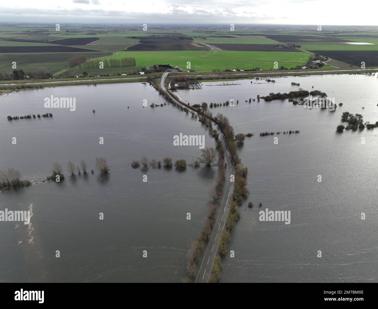 The Welney wash fills with floodwater and the road is becoming flooded ...