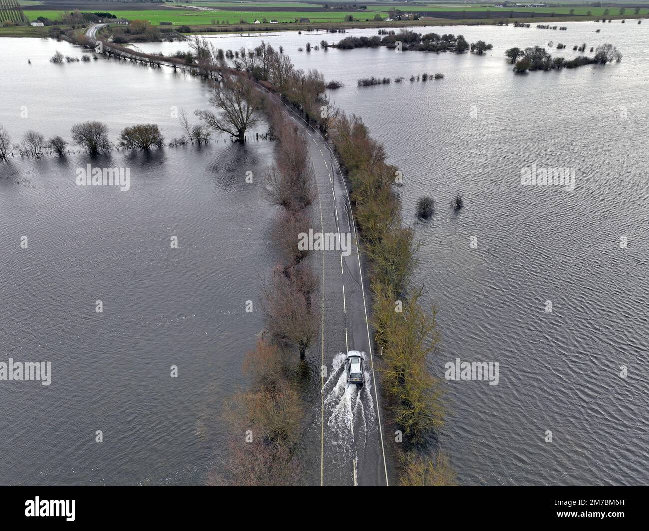 The Welney wash fills with floodwater and the road is becoming flooded ...